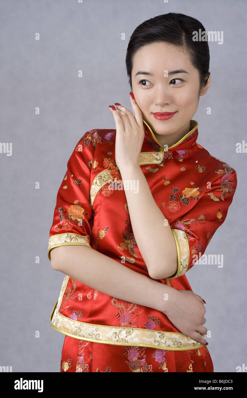 Young woman in cheongsam posing Stock Photo - Alamy