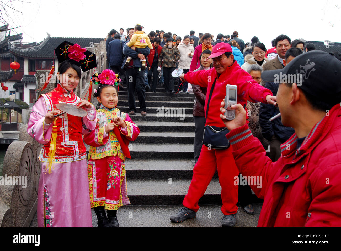 Two young girls in Manchuria custom posing to take pictures using ...