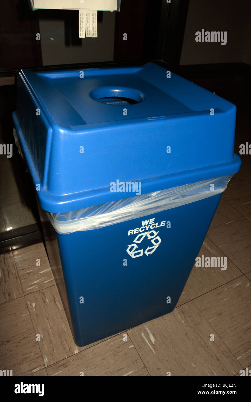 A blue recyclables trash can with triangular recycle symbol and round ...