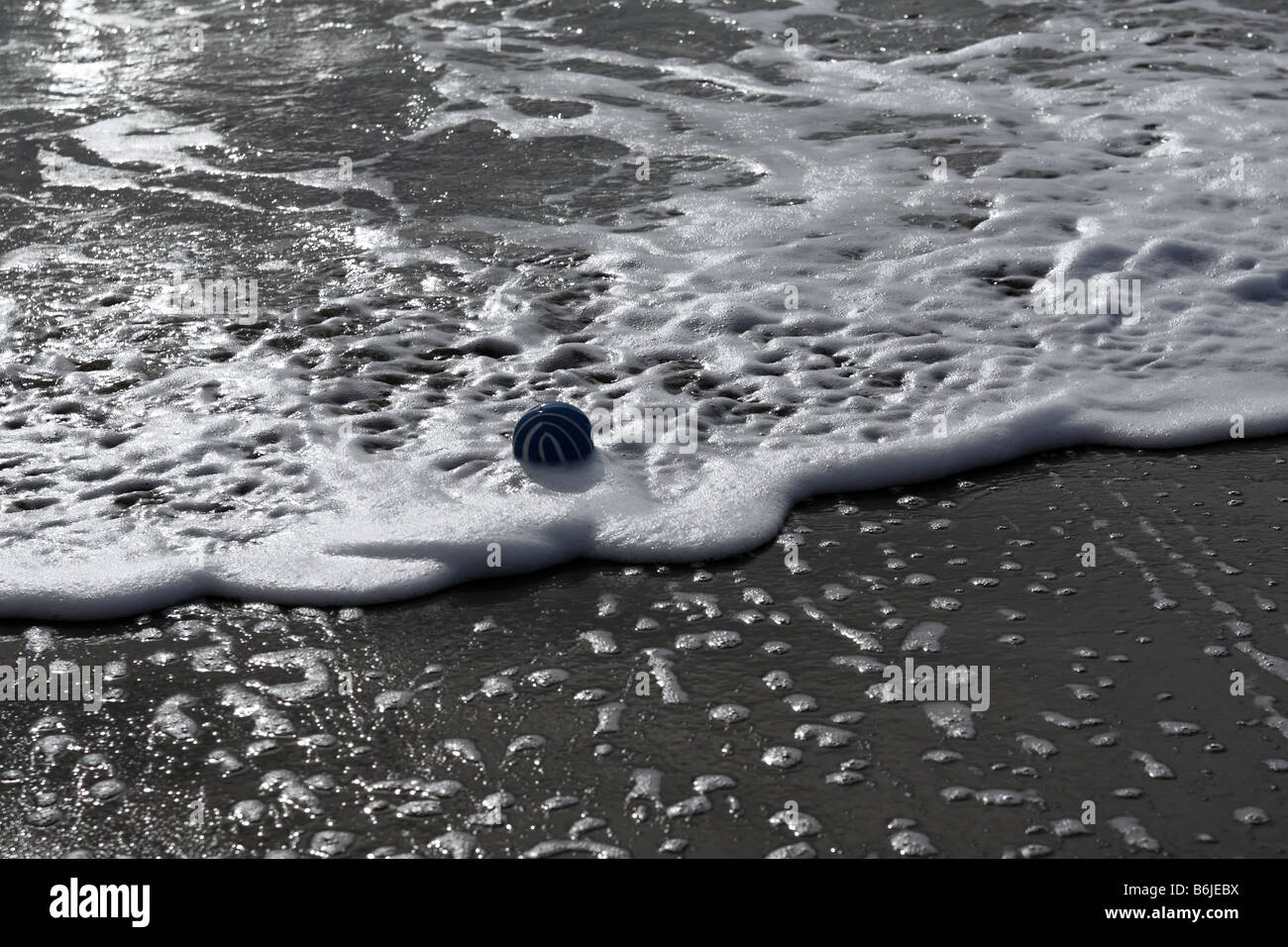 Blue Rubber Ball Washed up on Beach Stock Photo - Alamy