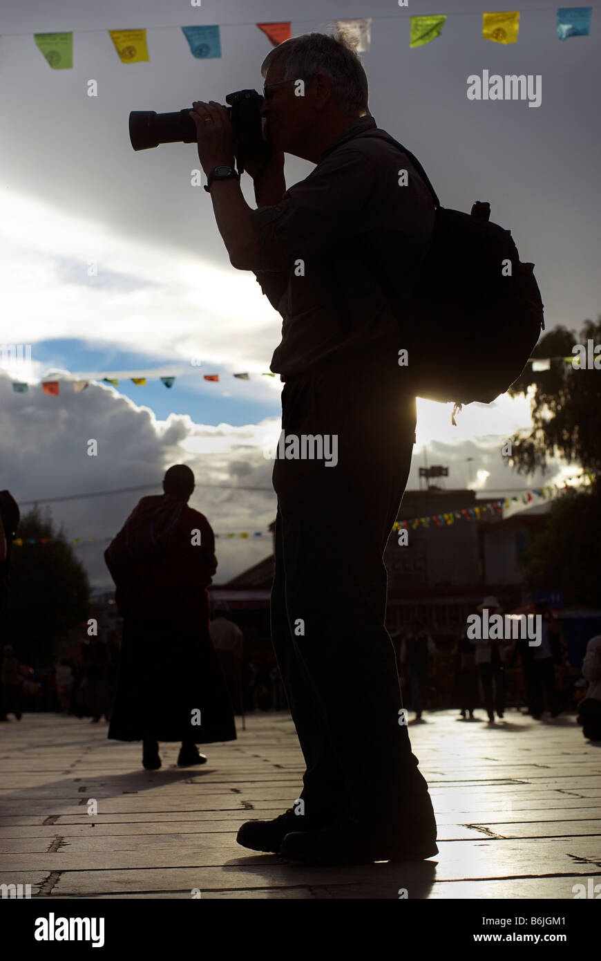 Silhouette of a photographer with a professional camera composing a ...