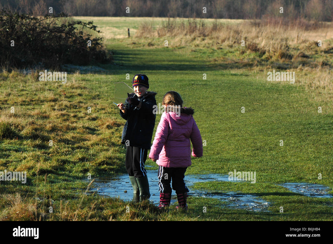 A brother and sister breaking ice Stock Photo - Alamy