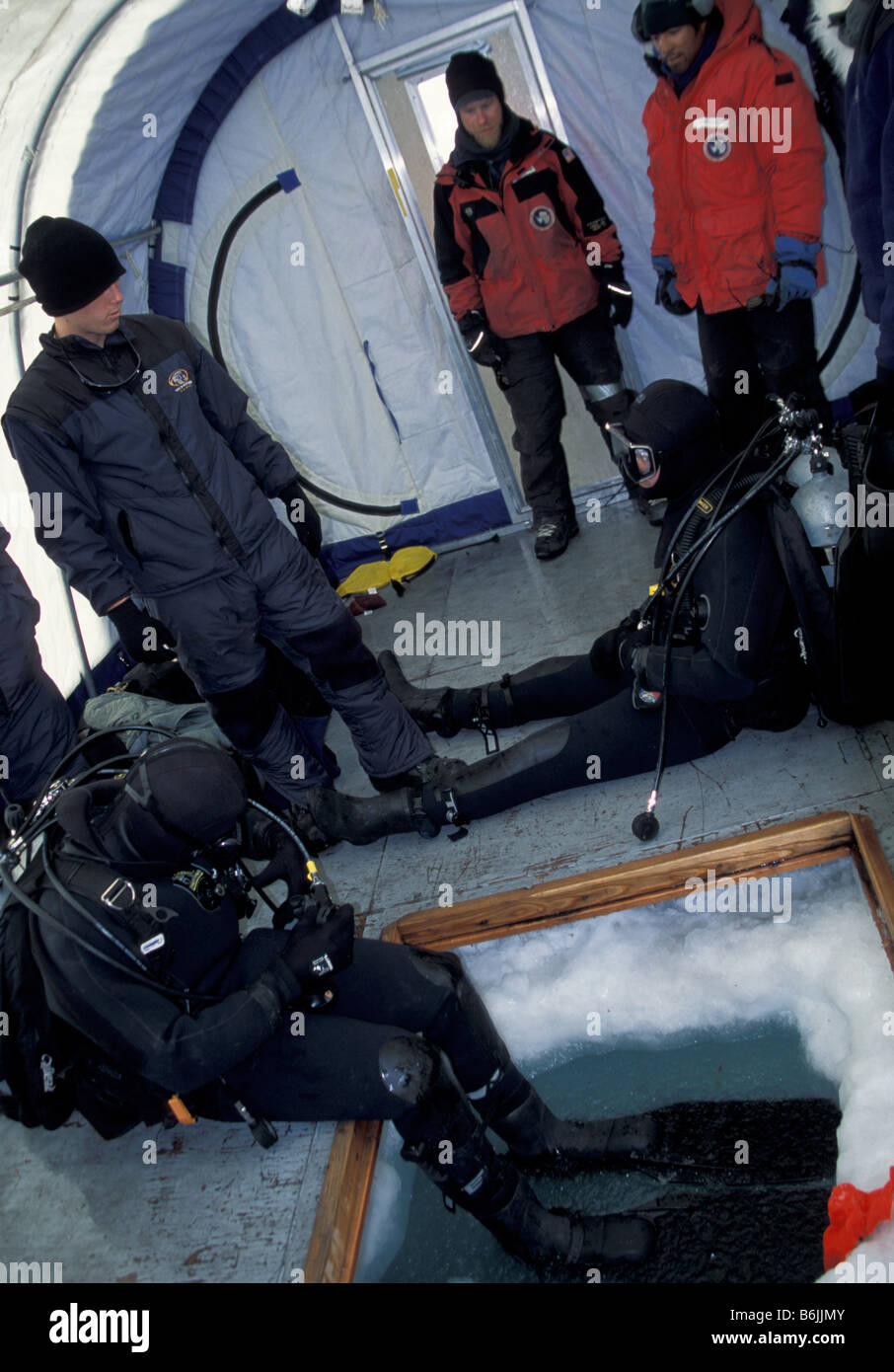 Antarctica, Ross Island, McMurdo Station, USCG diver prepares for dive ...