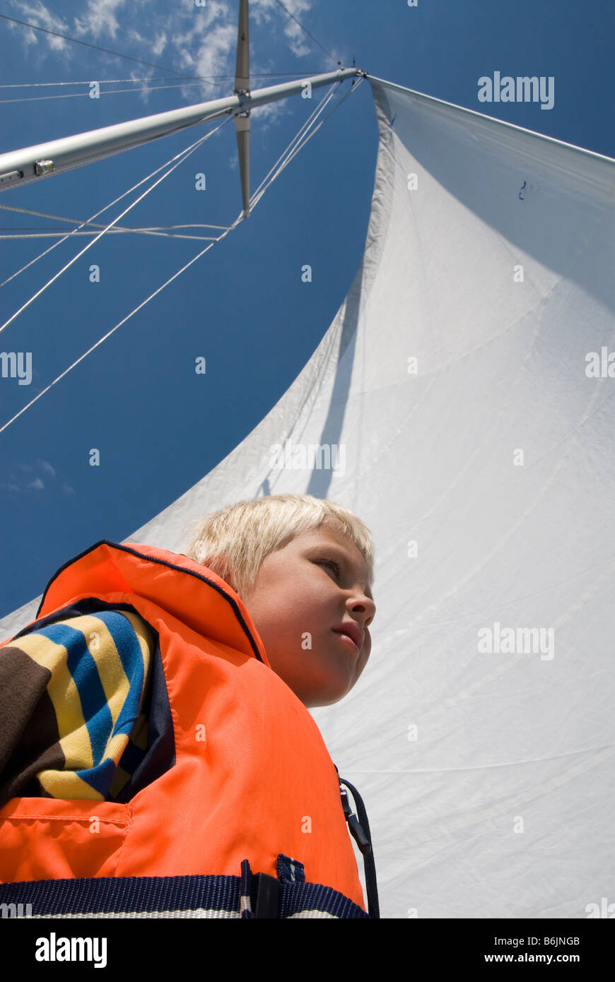 Young boy with sail in background looking forward Stock Photo - Alamy