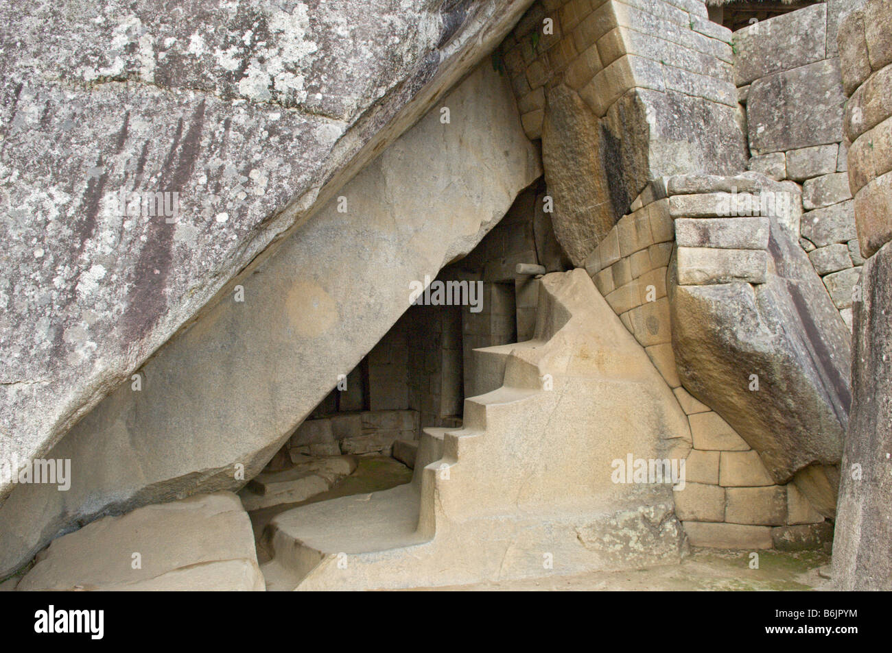 Peru, Machu Picchu, Sculpted stone at natural cave below Temple of the ...