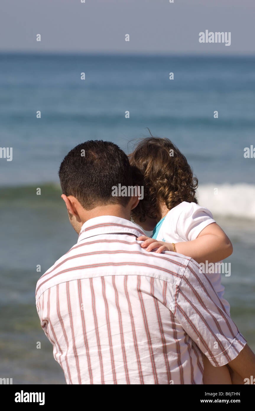 Man carrying child by the sea Stock Photo - Alamy