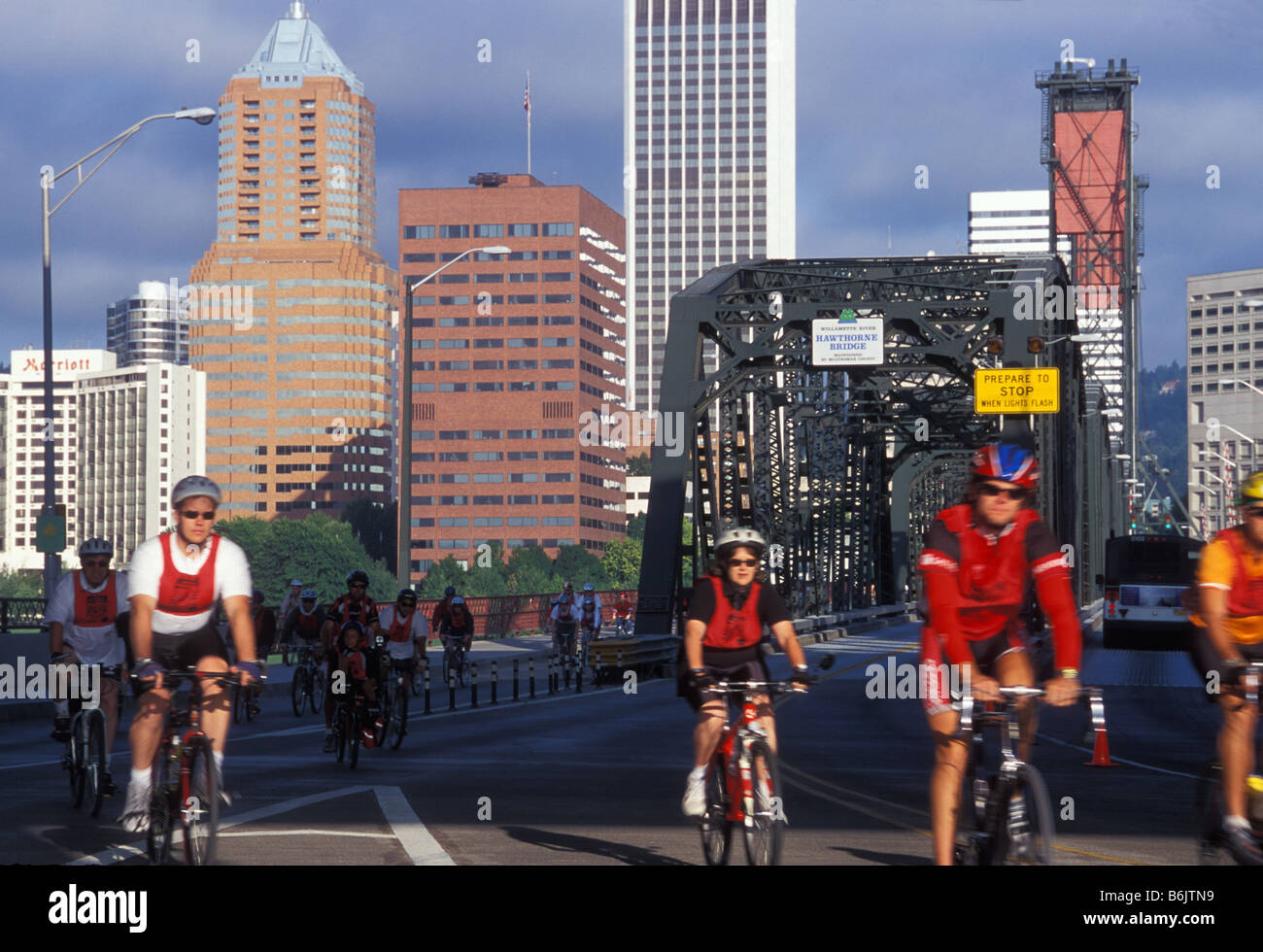 USA, Oregon, Portland, Bikers coming off of the Hawthorne Bridge during ...