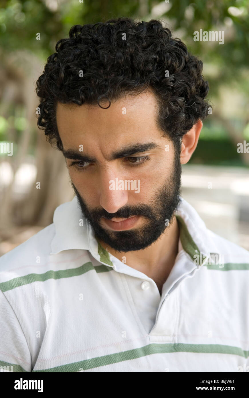 Young man looking down Stock Photo - Alamy