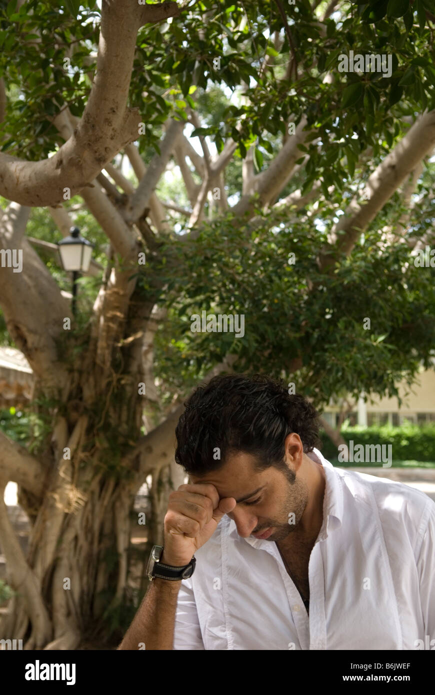Young man head in hands Stock Photo - Alamy
