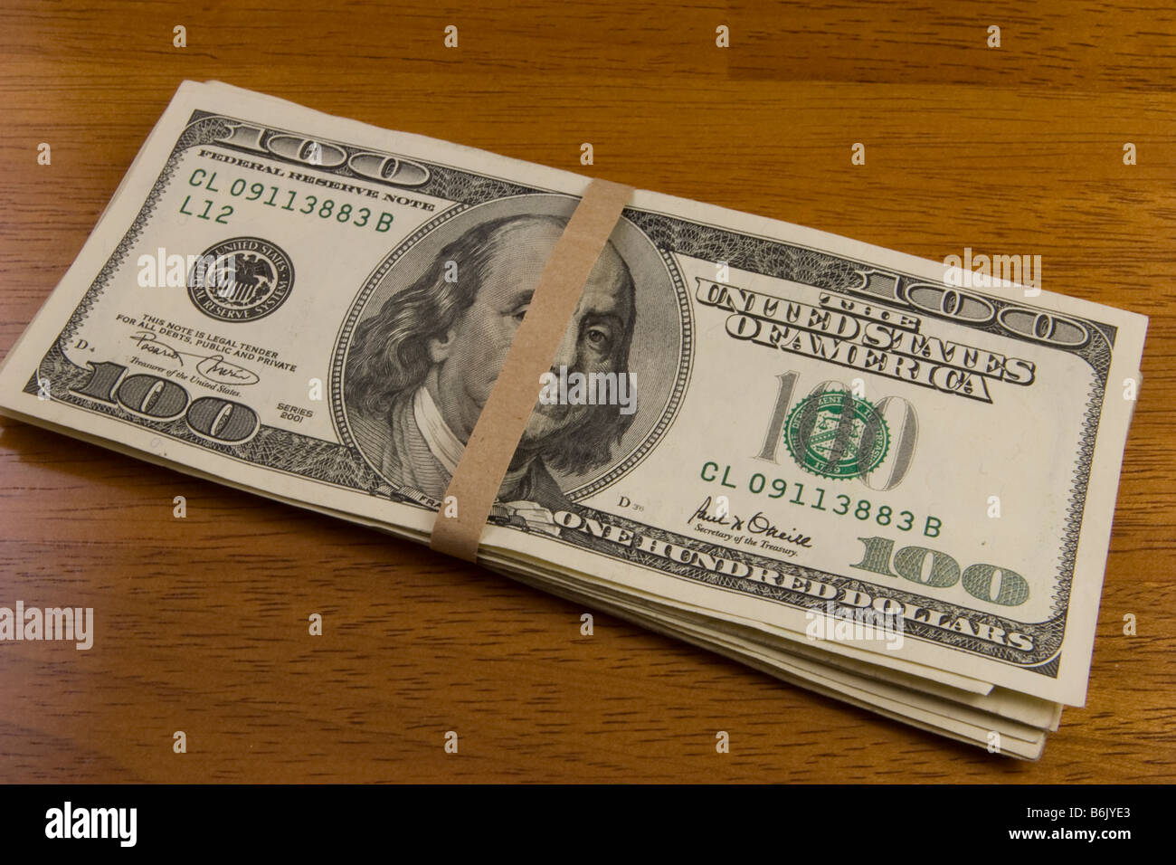 United States $100 dollar bills on wooden table Stock Photo - Alamy