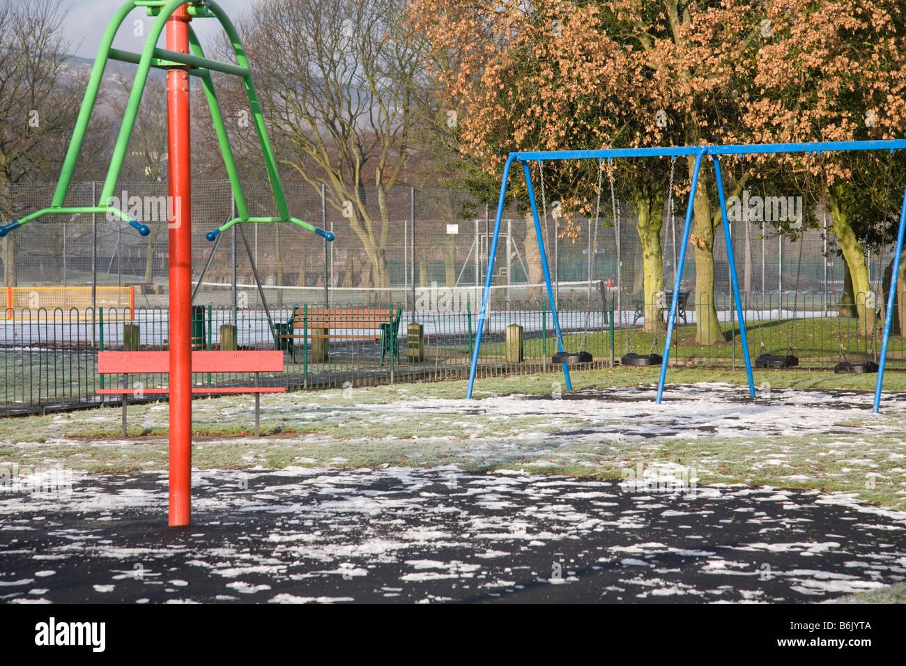 Childrens playground in Ramsbottom England on a snow and icy winters ...