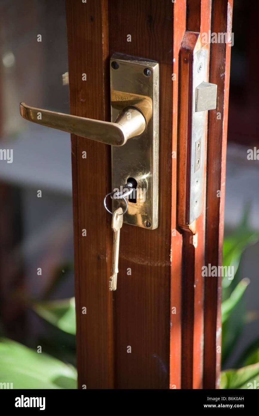 A key in door illustrating security Stock Photo - Alamy