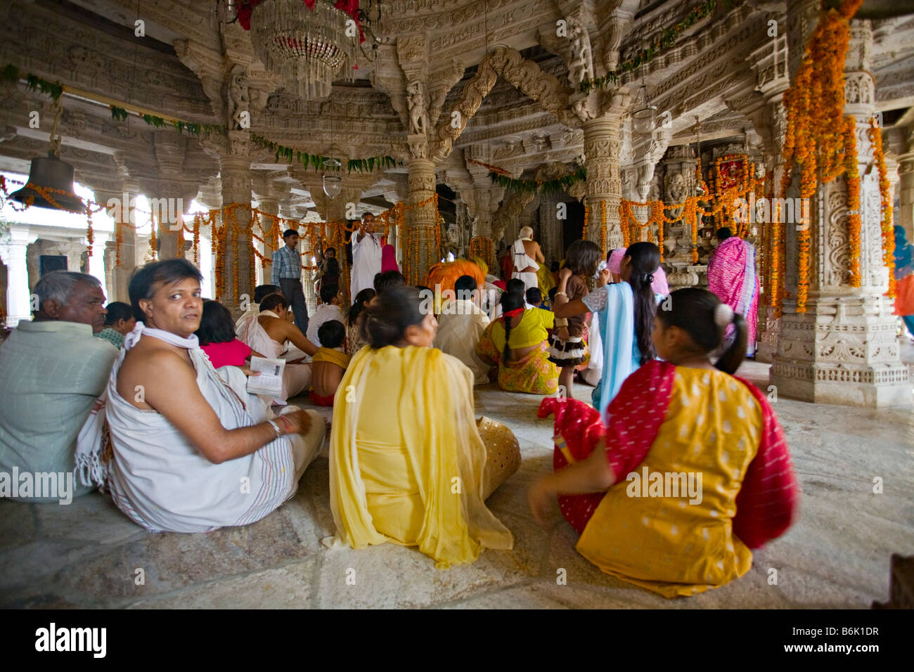 Devotees praying inside of Chaumukha Mandir Temple, Ranakpur, Rajasthan ...