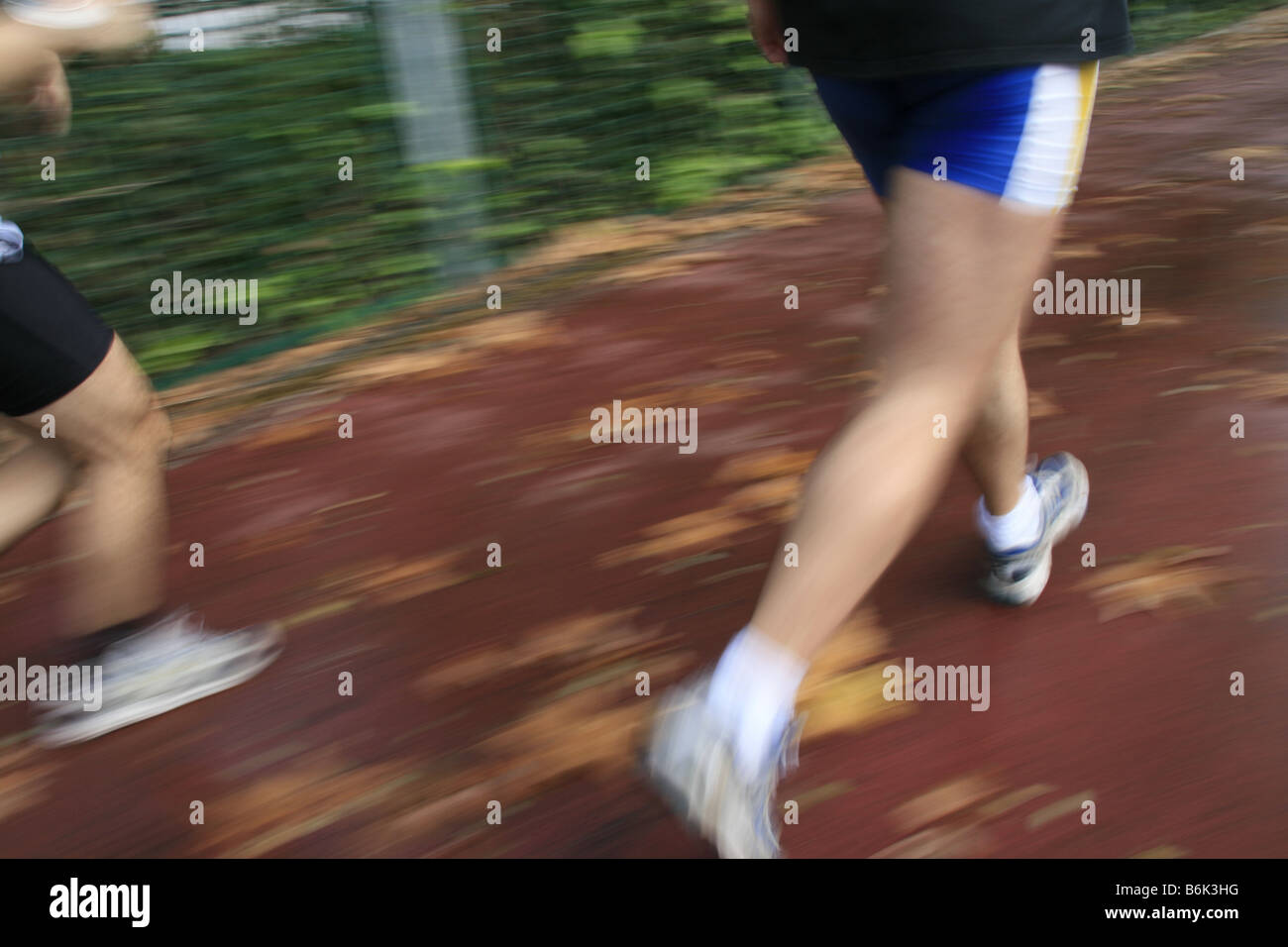 runners in action on country lane in road race Stock Photo - Alamy