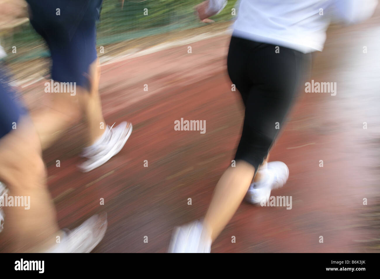 runners in action on country lane in road race Stock Photo - Alamy