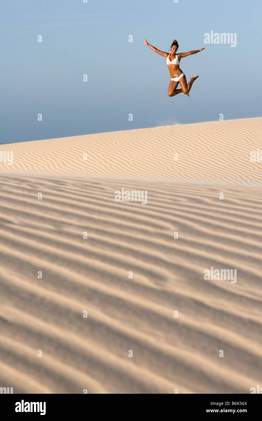 woman jumping above sand dune Stock Photo - Alamy