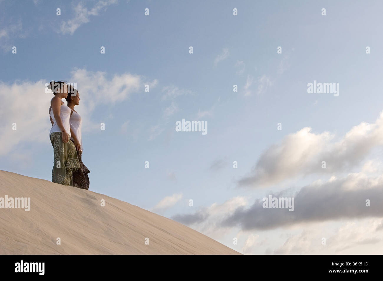 Two young women at beach side view Stock Photo - Alamy