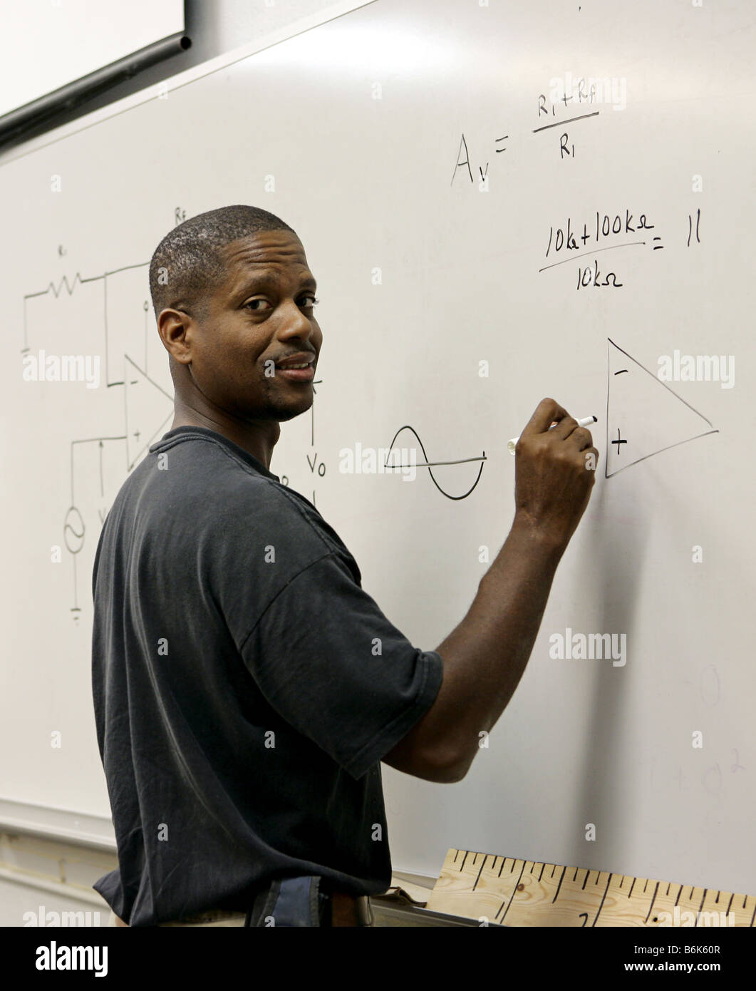 A handsome african american student at the board doing trigonometry ...