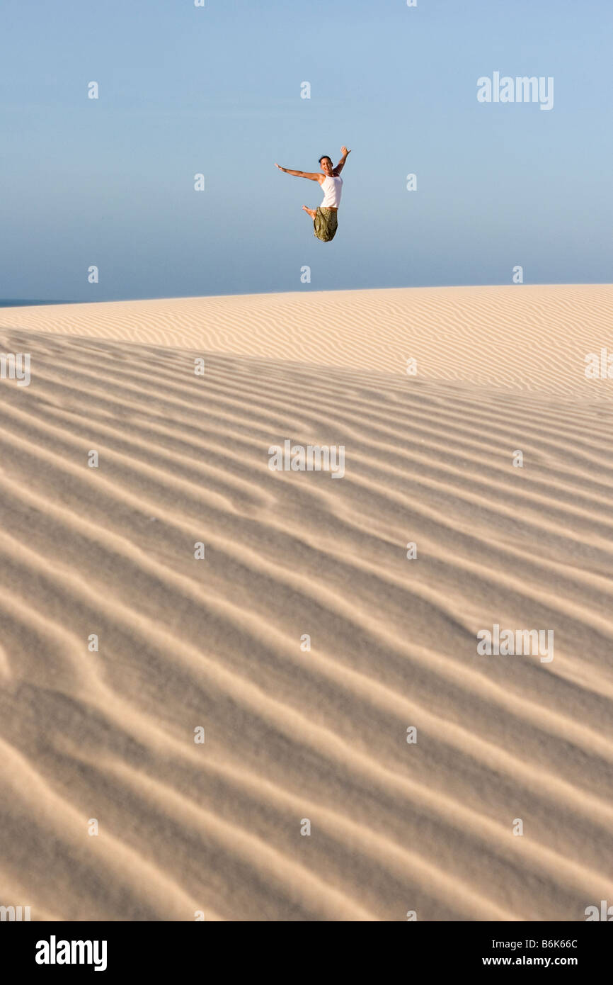 woman jumping above sand dune Stock Photo - Alamy