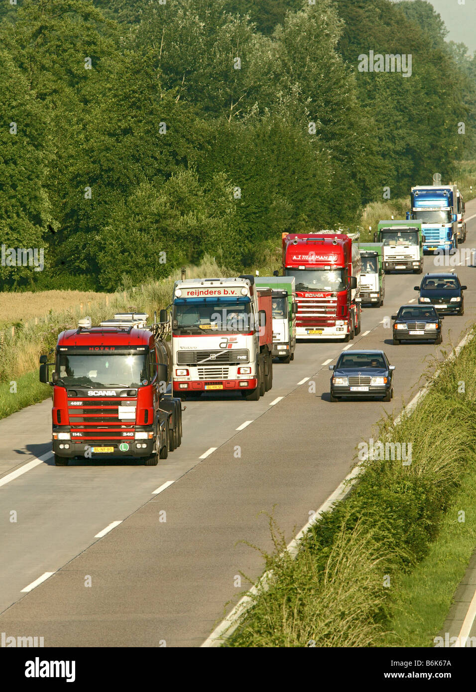 Trucks on a highway Stock Photo - Alamy