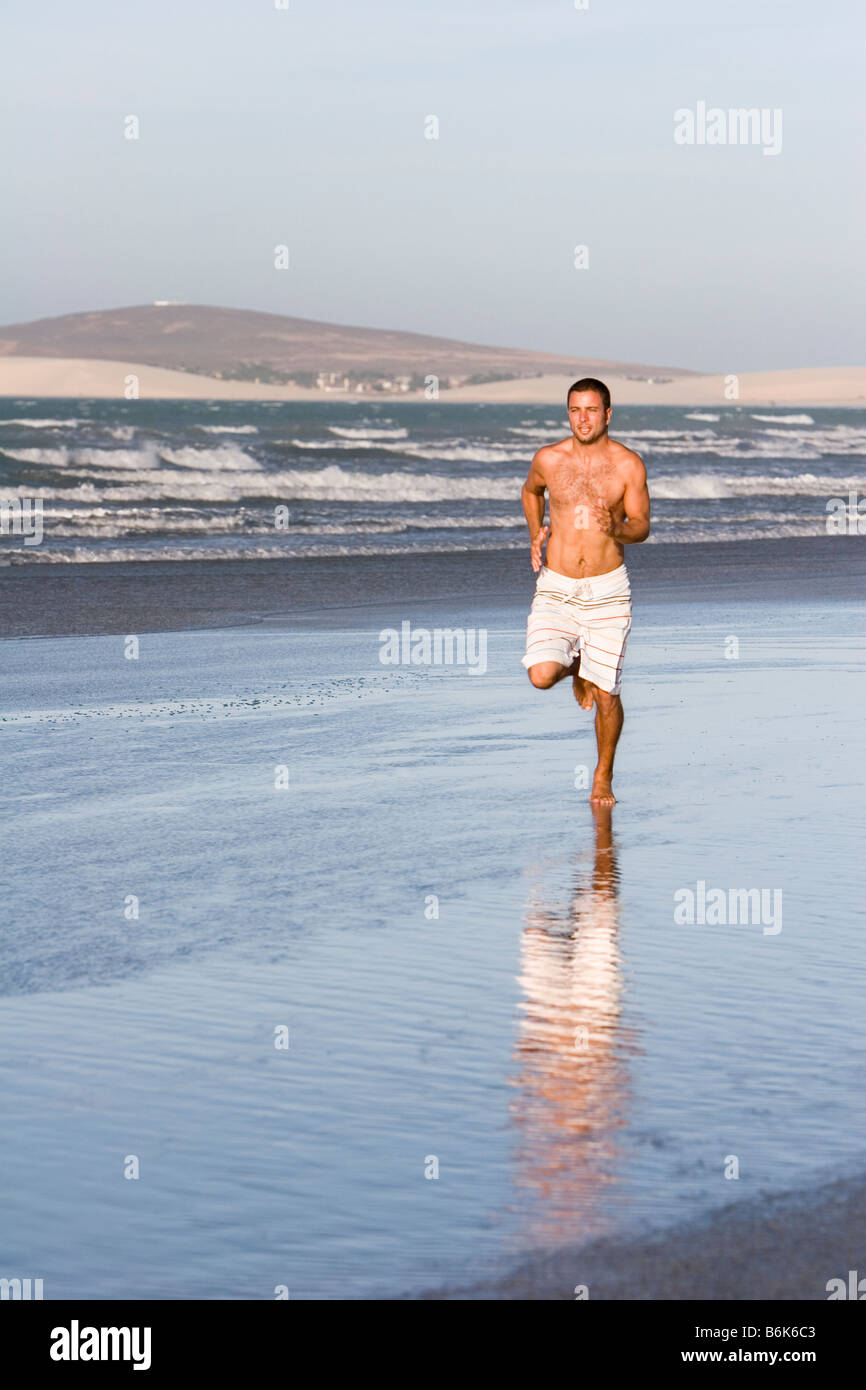 man running on the beach Stock Photo - Alamy