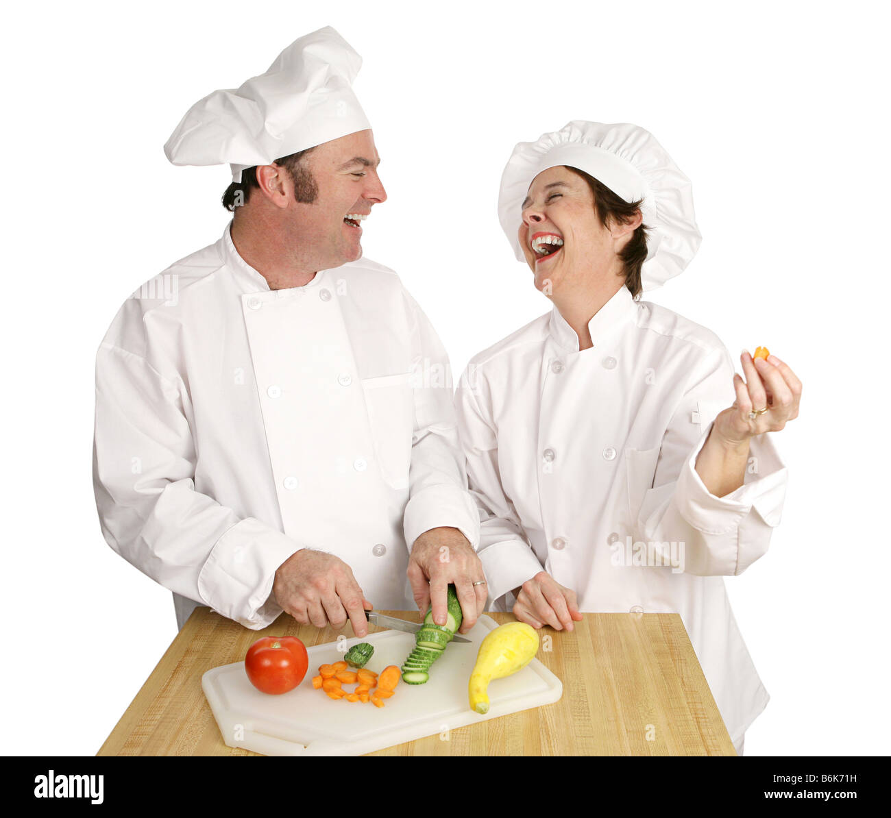 Two chefs goofing around and laughing in the kitchen as they work ...