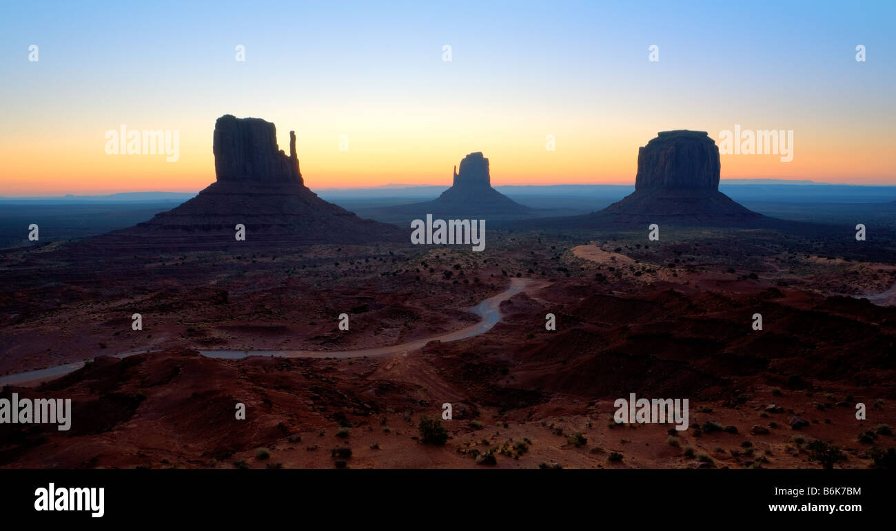 Dawn colors behind "the Mittens" and Merrick Butte Stock Photo - Alamy