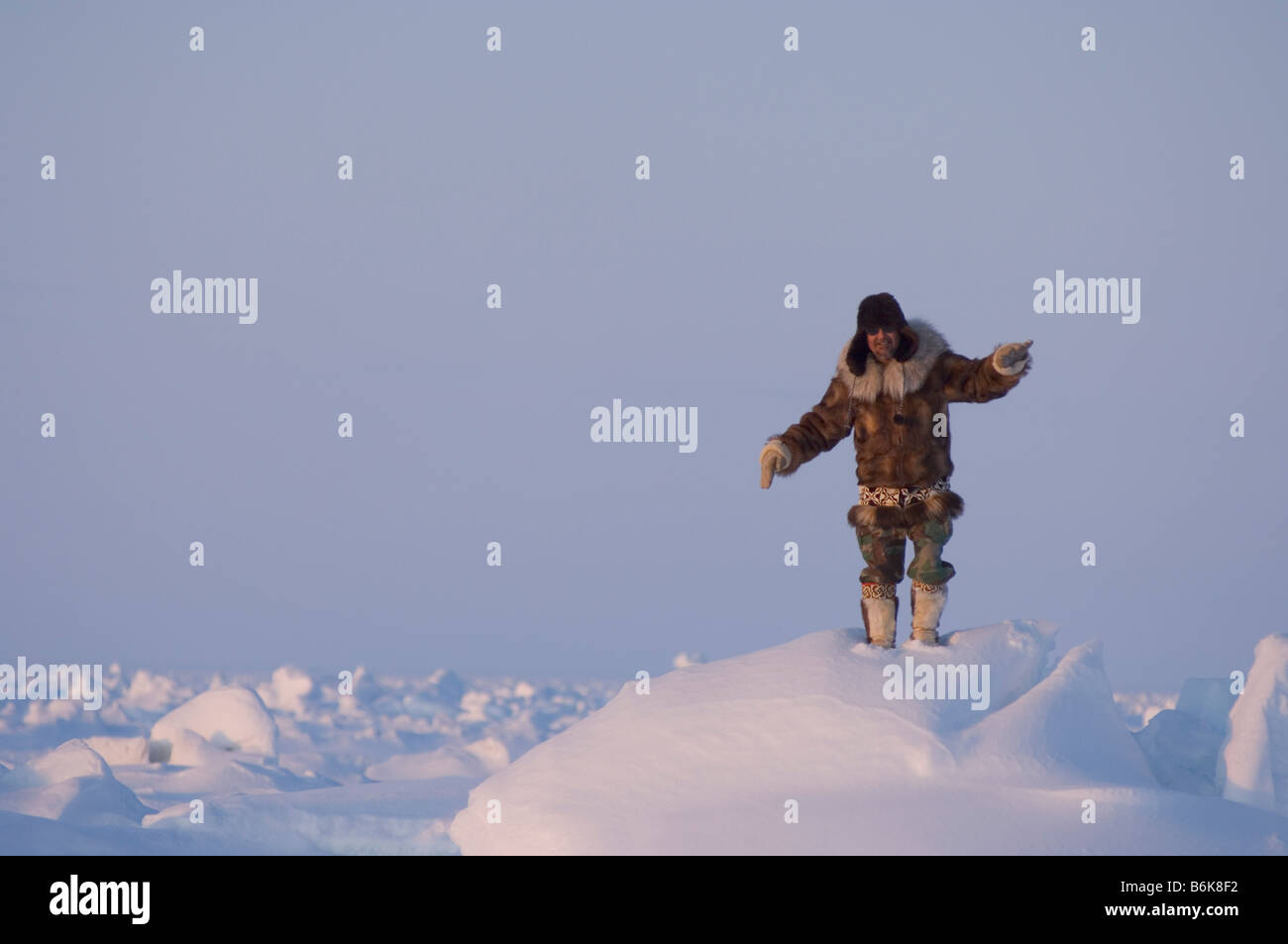 Inupiaq subsistence whaler peeks his head in a wall tent on the pack ...