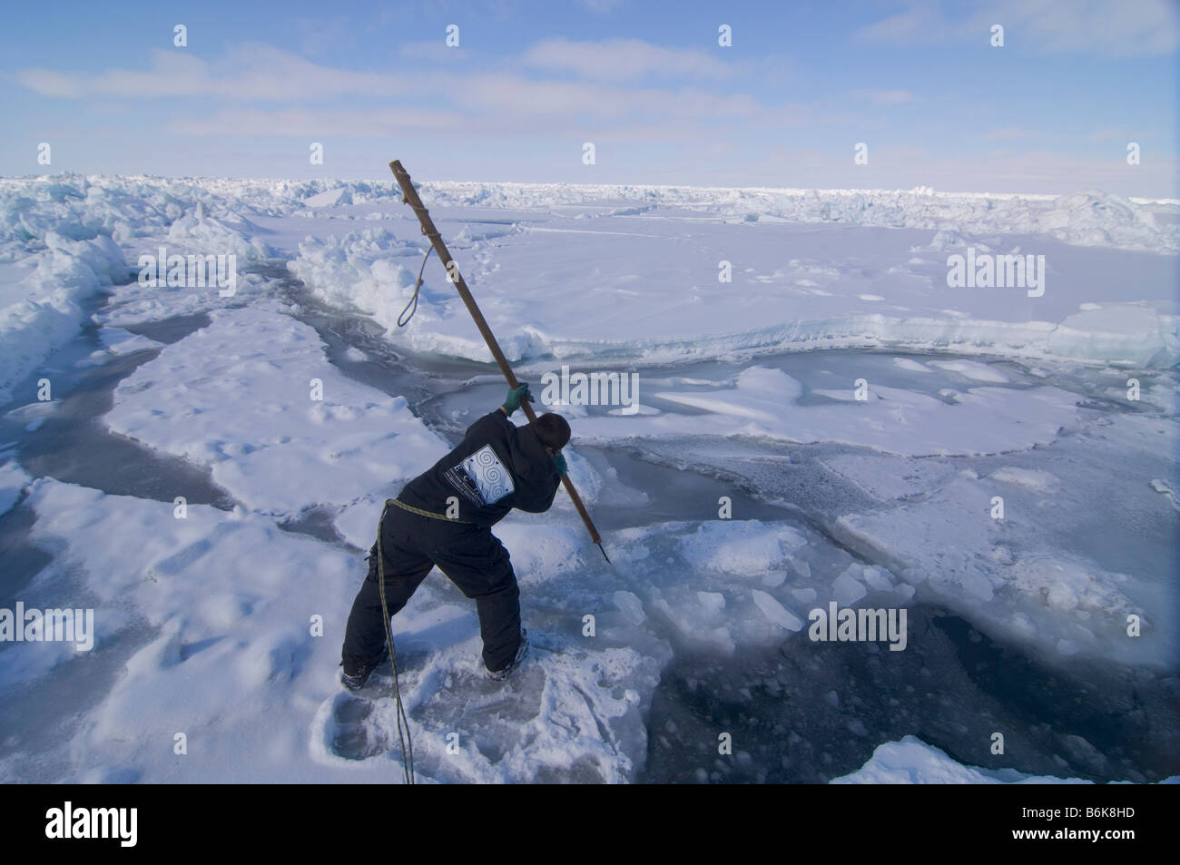 Inupiaq subsistence hunter reopens a hole in the pack ice for potential ...