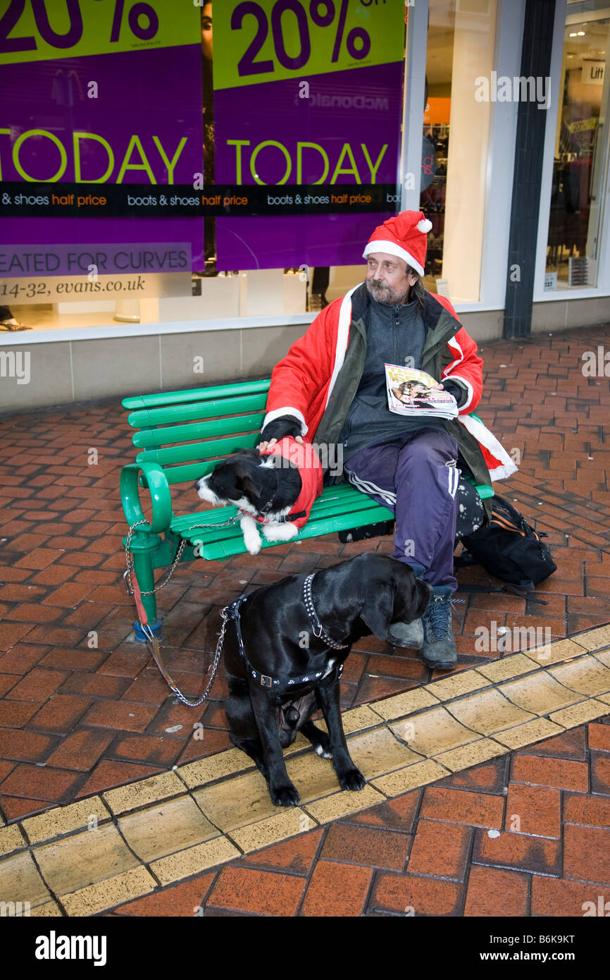 Seated homeless Tramp wearing Father Christmas outfit in Derby High ...