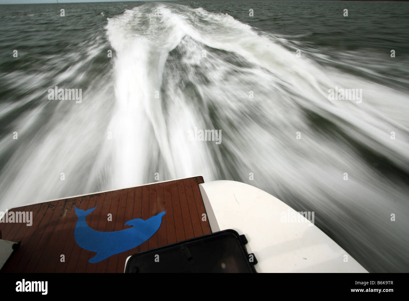 RUSHING WATER BEING PROPELLED FROM THE REAR OF A JET BOAT HORIZONTAL ...