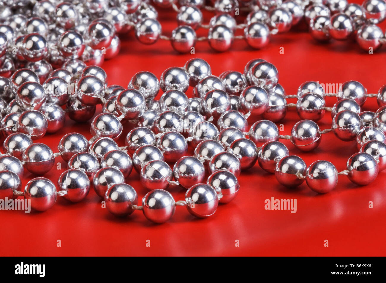 Close-up of a string of silver beads Stock Photo - Alamy