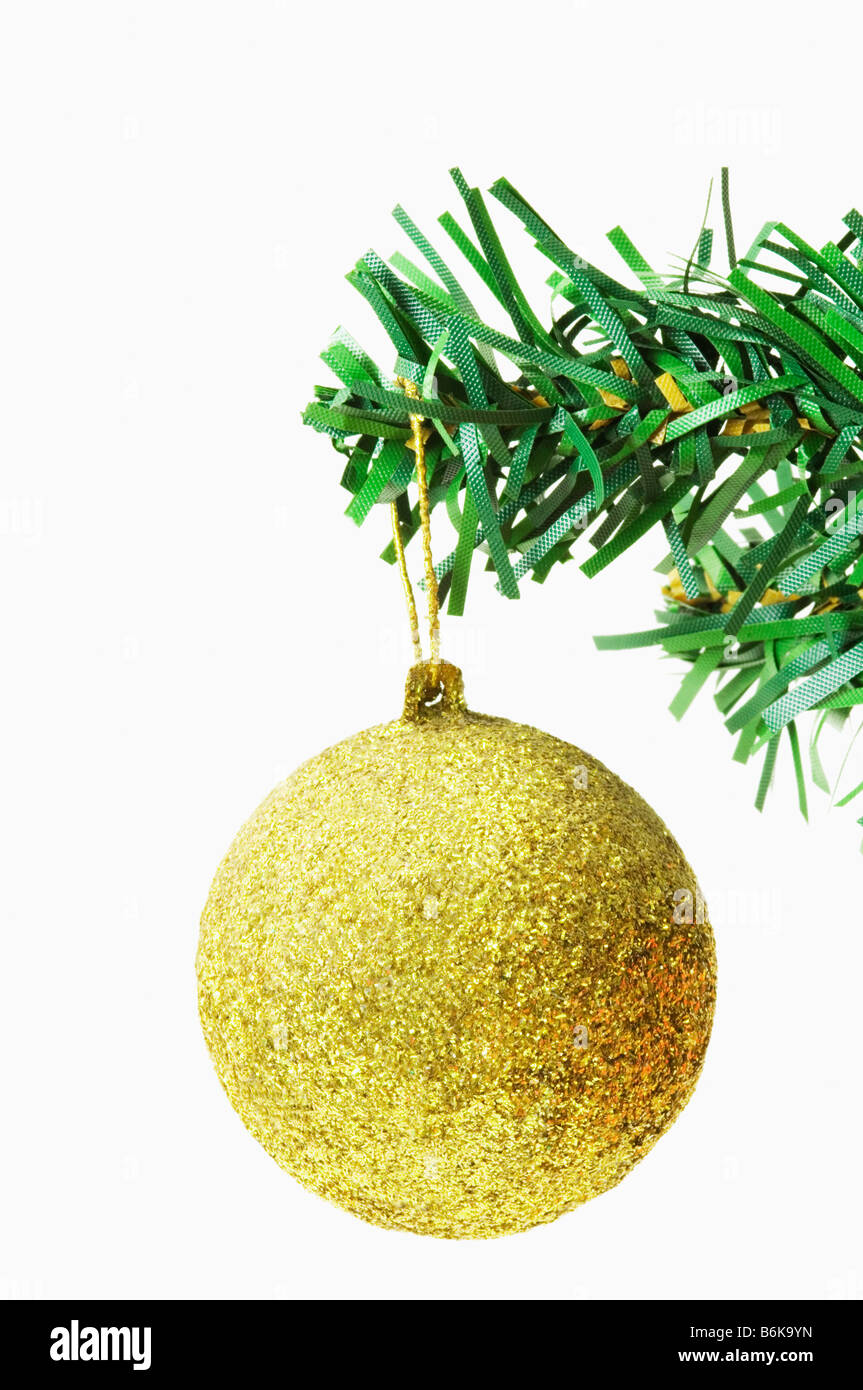 Golden bauble hanging on a Christmas tree Stock Photo - Alamy