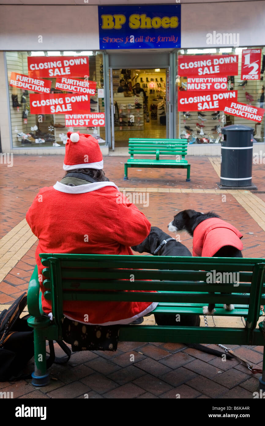 Seated homeless Tramp wearing Father Christmas outfit in Derby High ...
