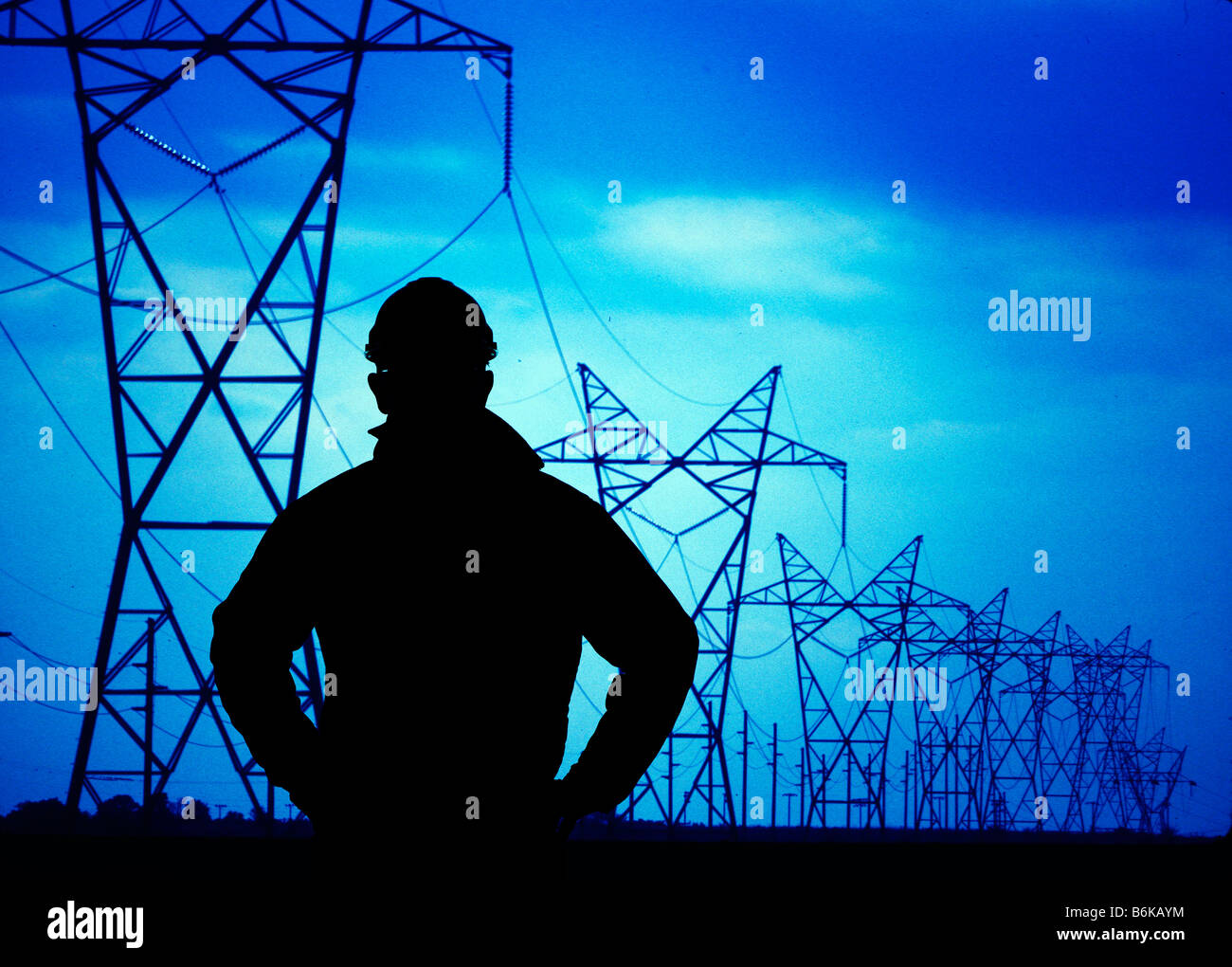 power manager checking on large power transmission lines and towers ...
