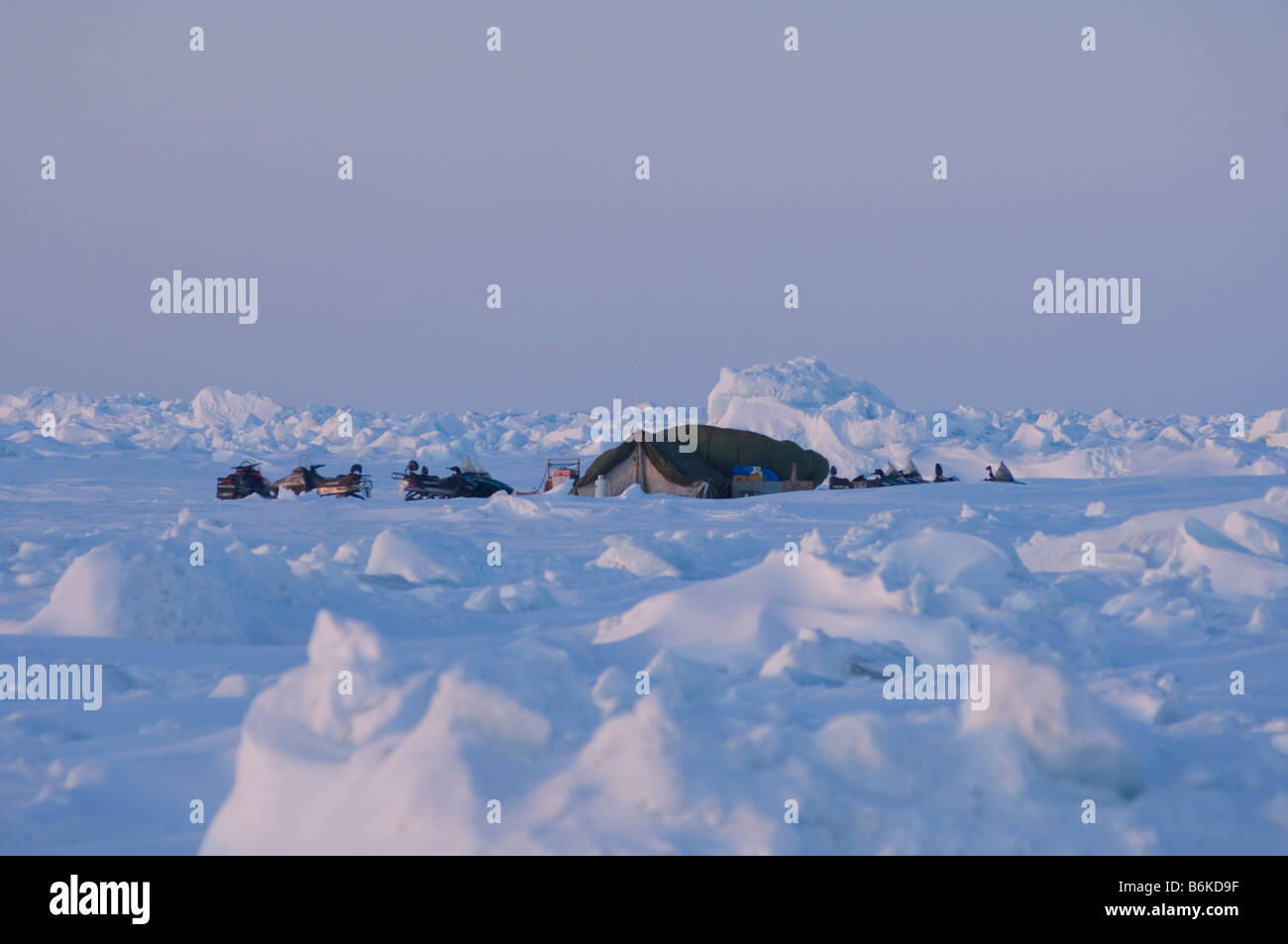 Wall tent and snowmachines out on the pack ice over the Chukchi Sea ...