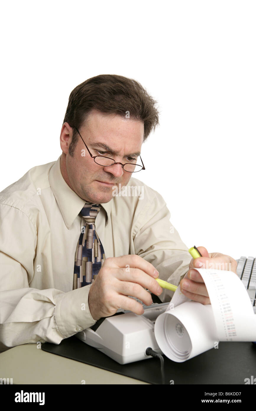 A man going over his accounts using a highlighter to identify issues ...