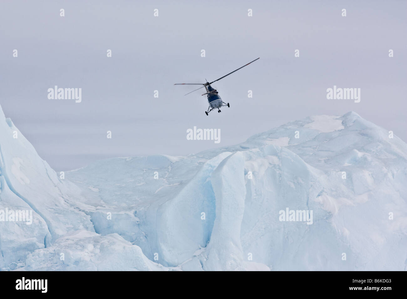 Helicopter flying over icebergs and pack ice at Snow Hill, Antarctica ...