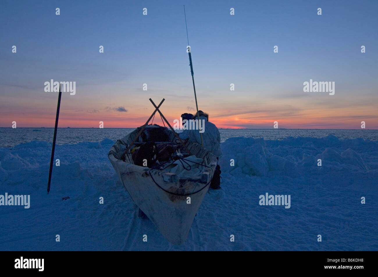 Inupiaq whalers with a seal skin boat or umiak wait and watch for ...
