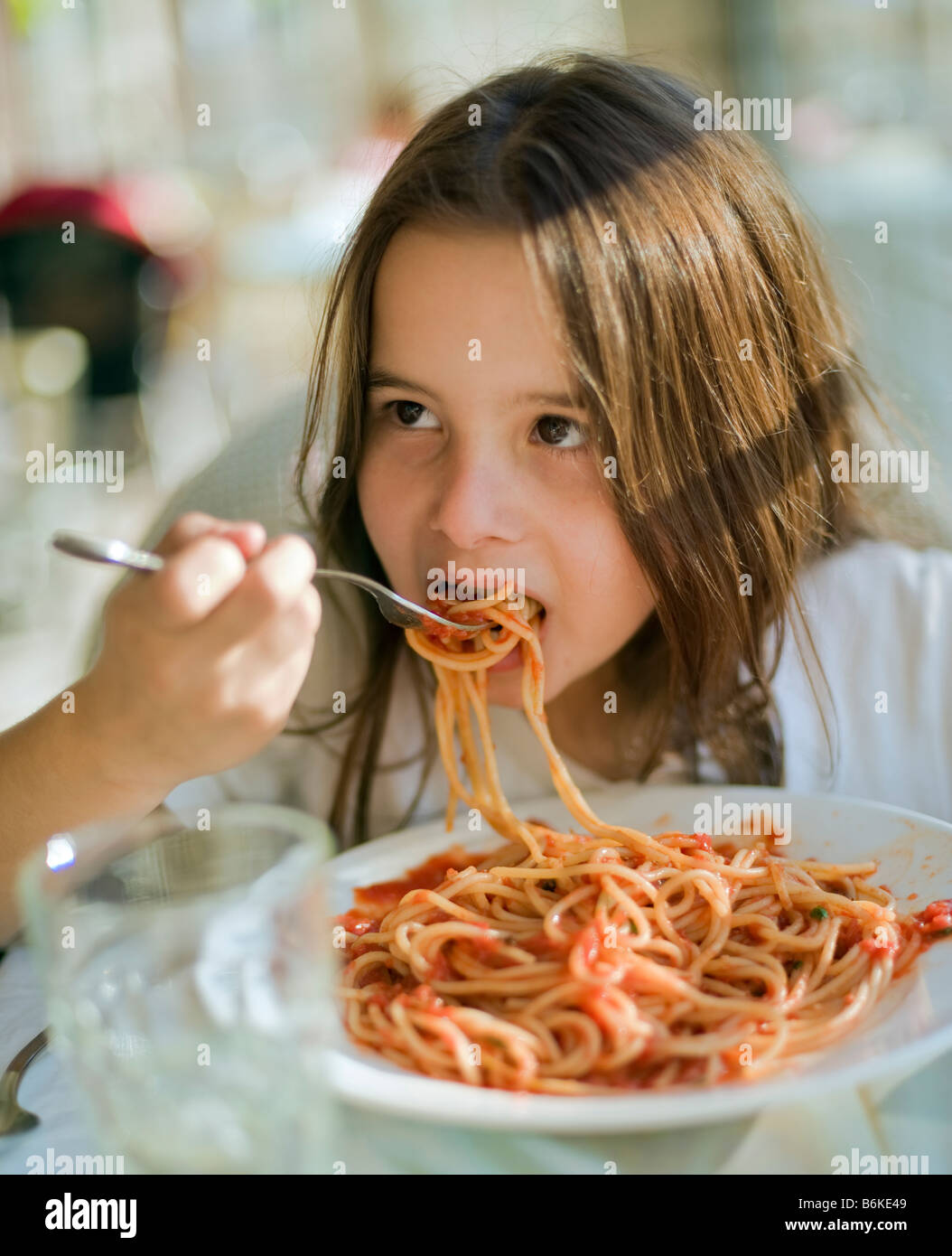 young girl eating spaghetti in restaurent Stock Photo - Alamy