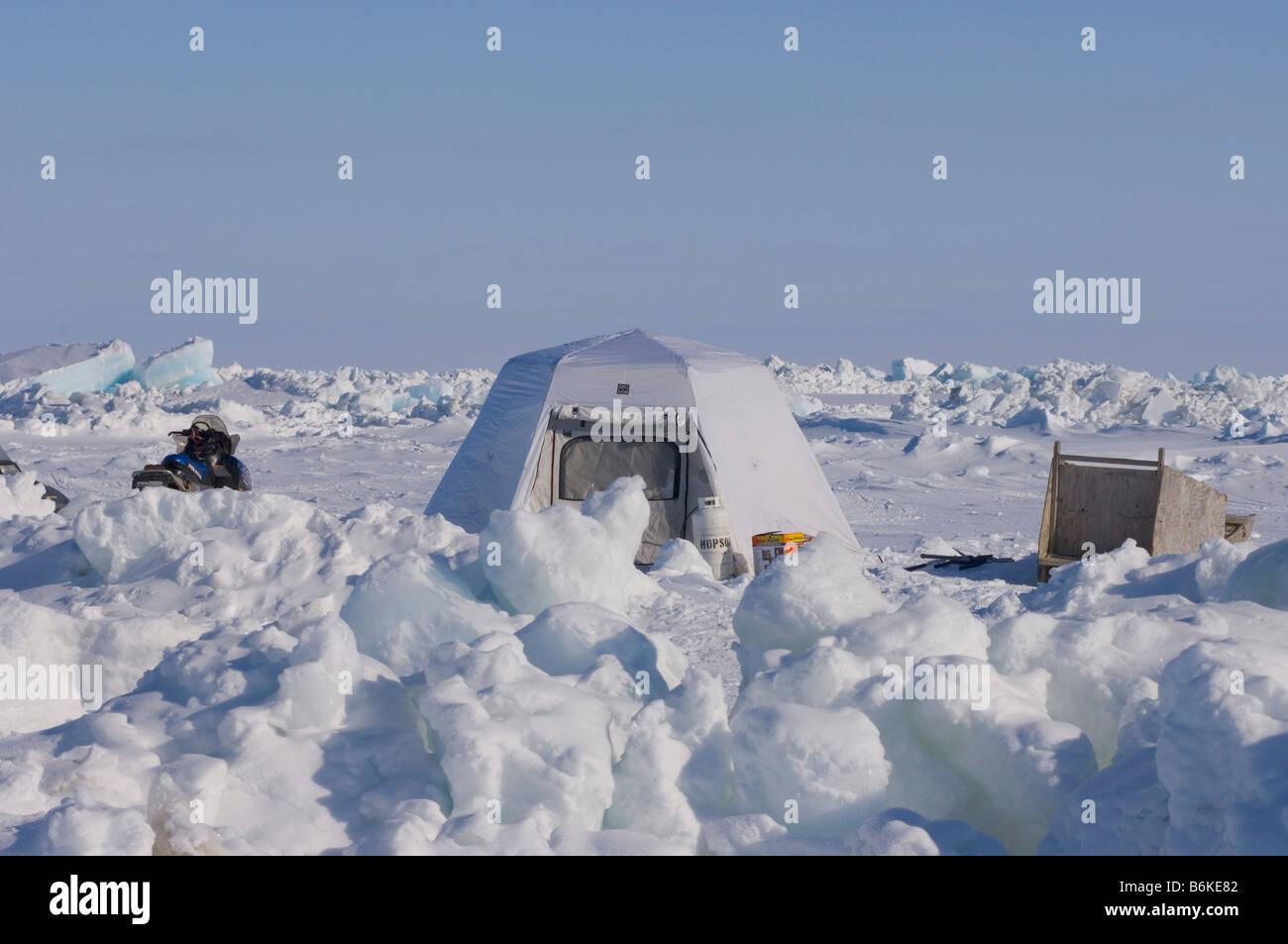 Arctic oven tent and snowmachines out on the pack ice over the Chukchi ...