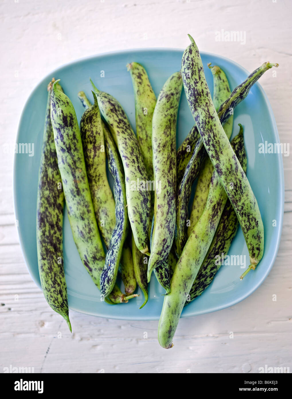 speckled fresh green beans on a square plate Stock Photo - Alamy