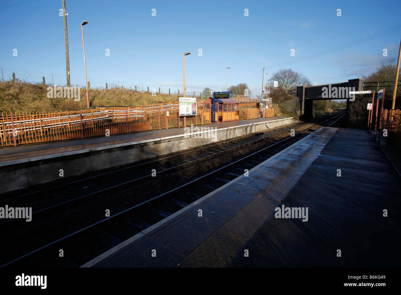 A station on a railway line in the countryside Stock Photo - Alamy