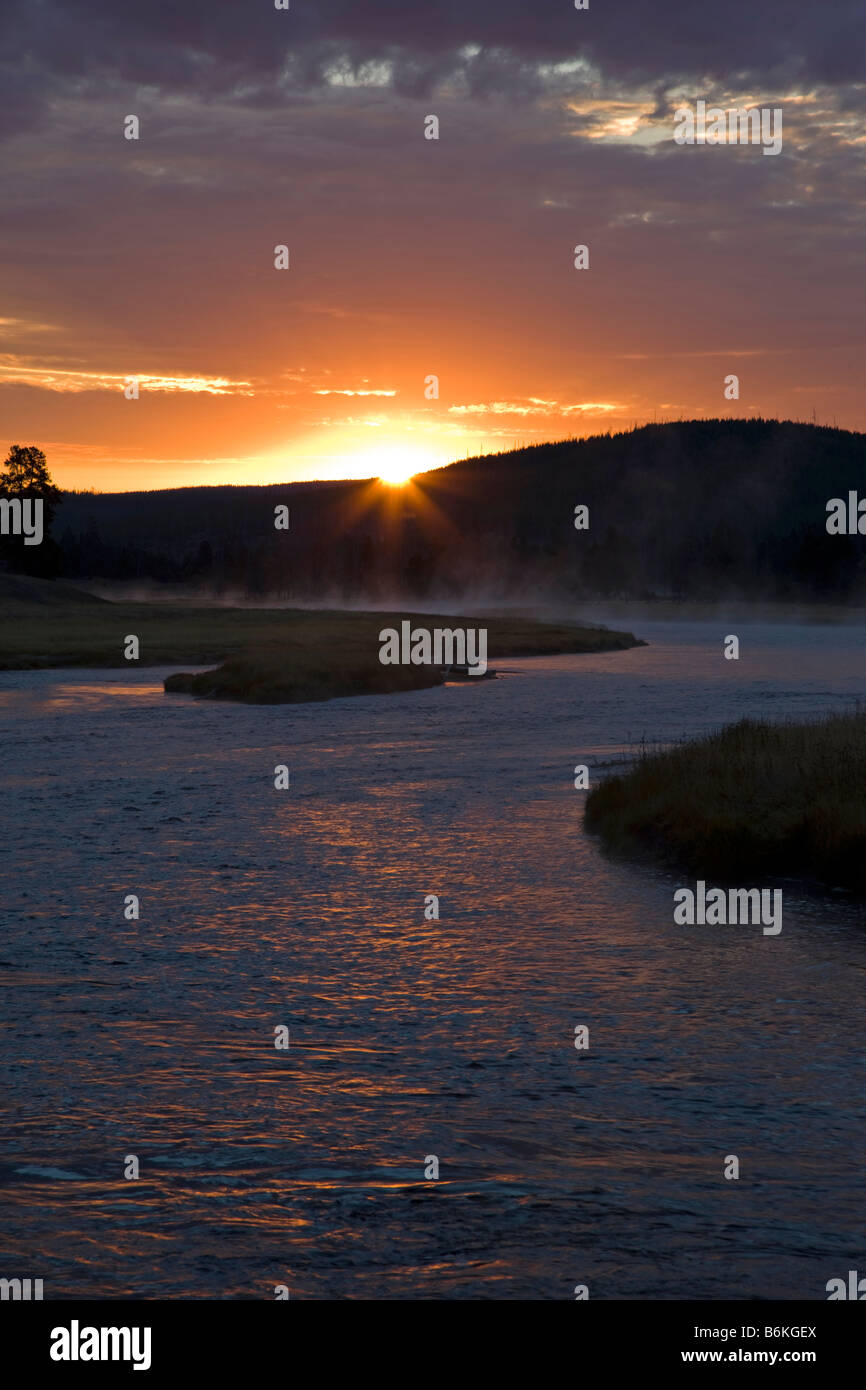 Steam rises at sunrise over the Madison River, Yellowstone National ...