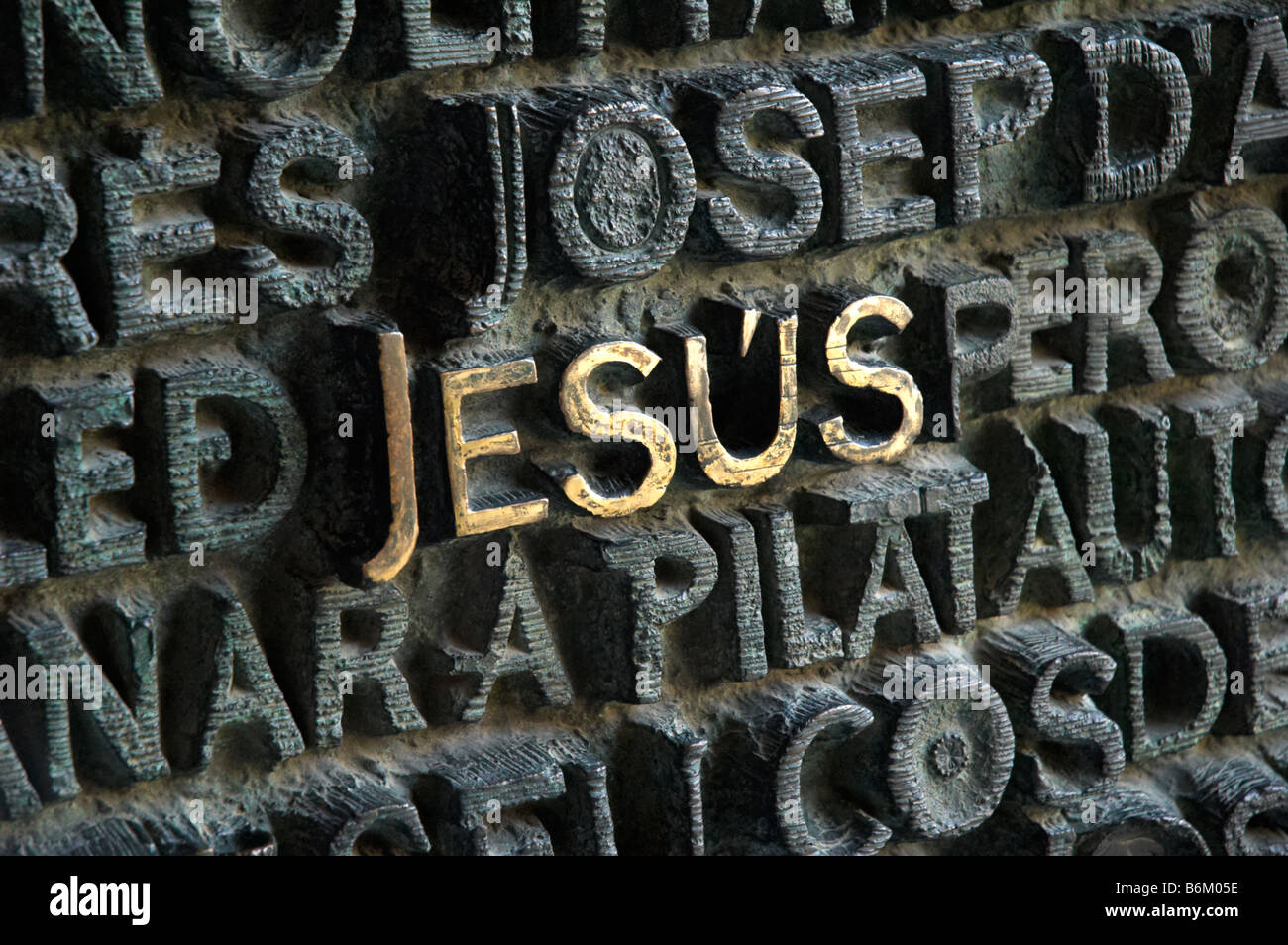 The word 'Jesus' highlighted in gold against a carved door at Antoni ...