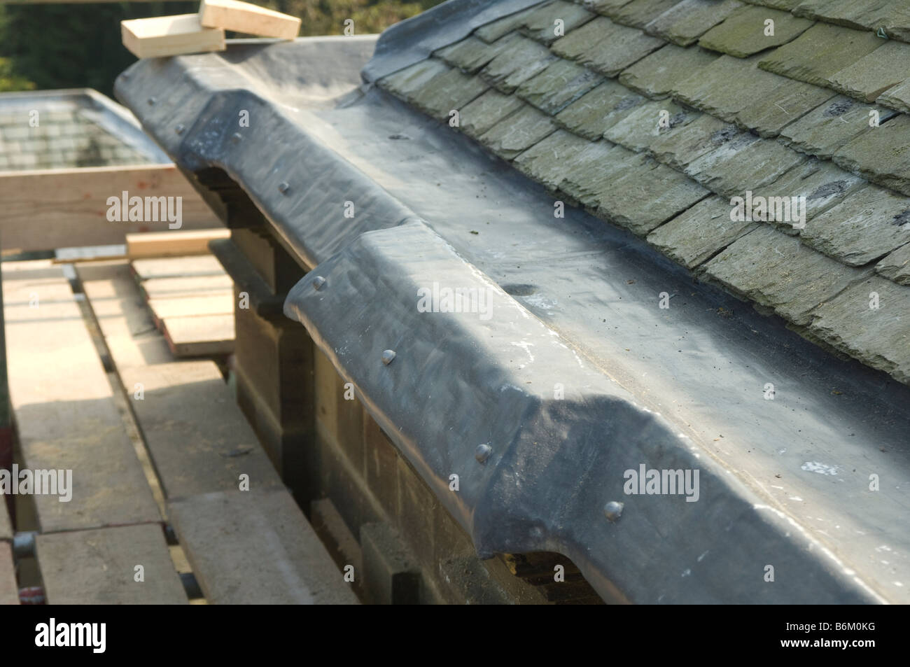 Lead lined gutter and wall capping on a traditional building roof Stock ...