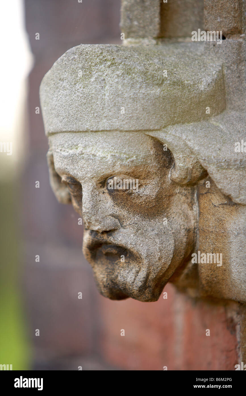 Victorian old stone carving of a male man's head with beard and hat ...