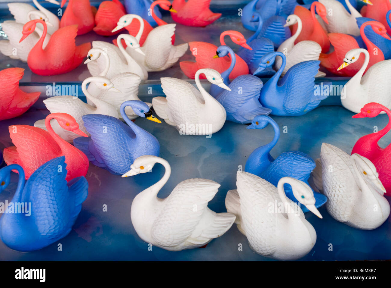 Plastic swans in fairground Stock Photo - Alamy