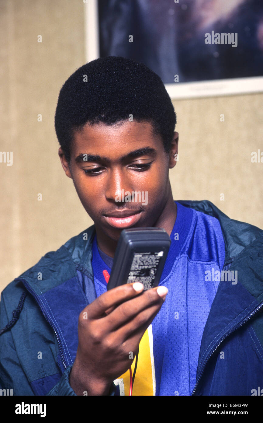 Black teen boy reads meter during physics class experiment in school ...