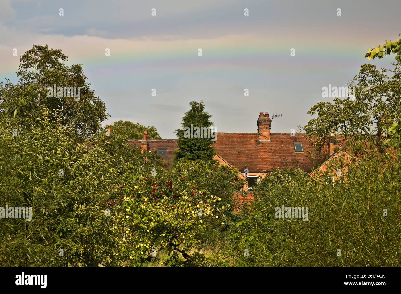 Suburban roof top crowned with a rainbow Stock Photo - Alamy